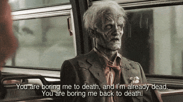 Video gif. Zombie with grayed, rotting skin, white hair, and a white ...
